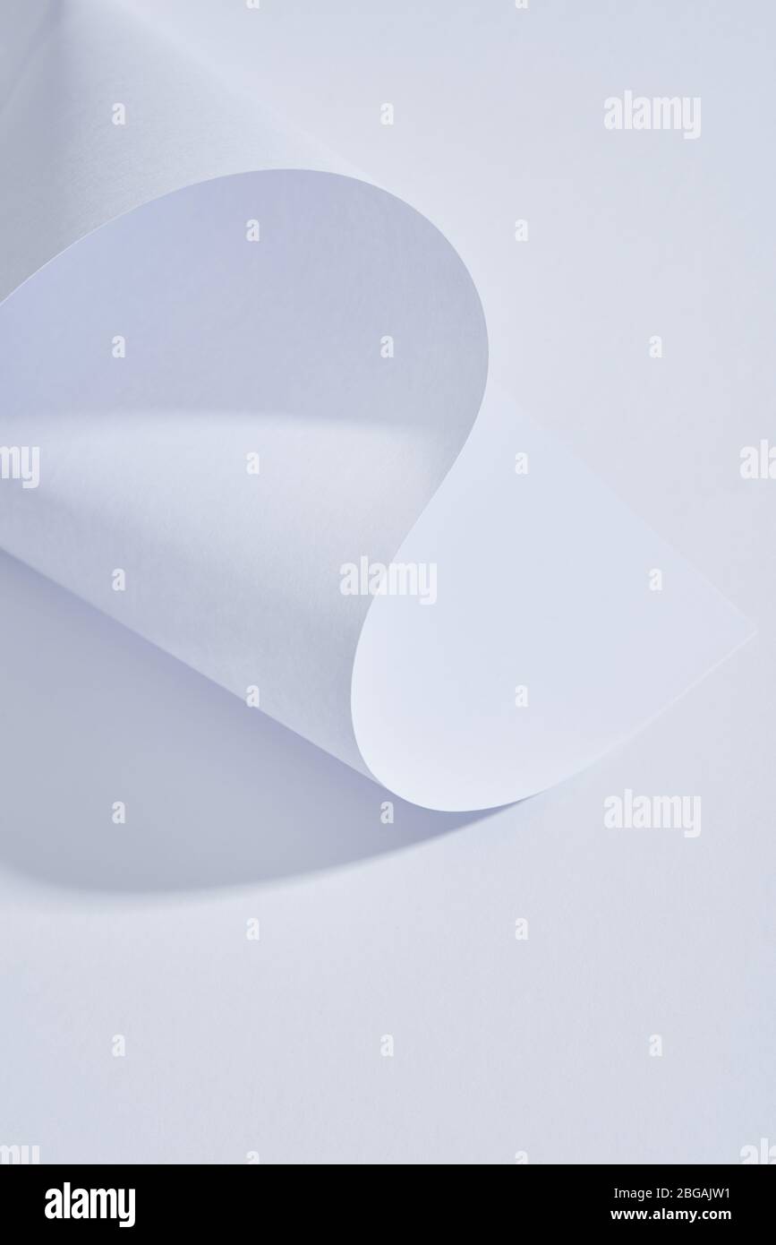 close up view of curved paper sheet on white background Stock Photo - Alamy