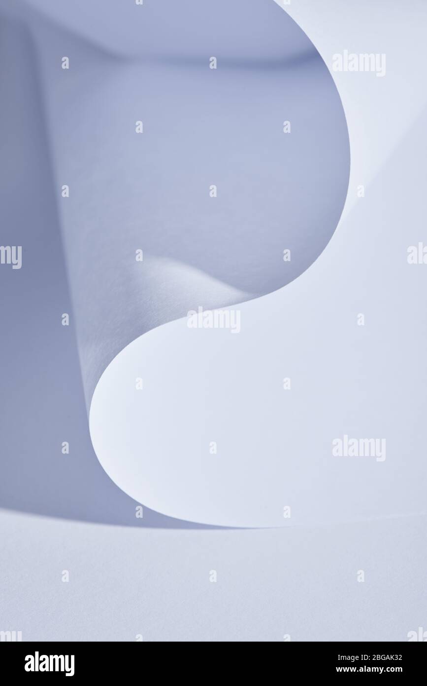 close up view of curved paper sheet on white background Stock Photo - Alamy