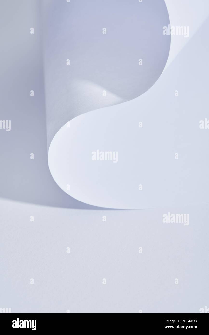 close up view of curved paper sheet on white background Stock Photo - Alamy