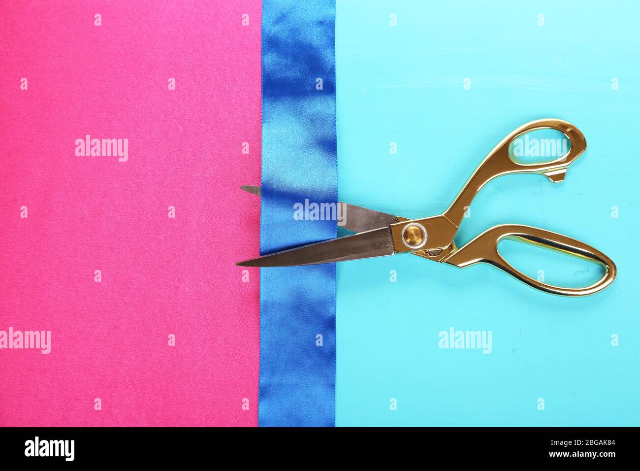 Scissors on color fabric background Stock Photo - Alamy