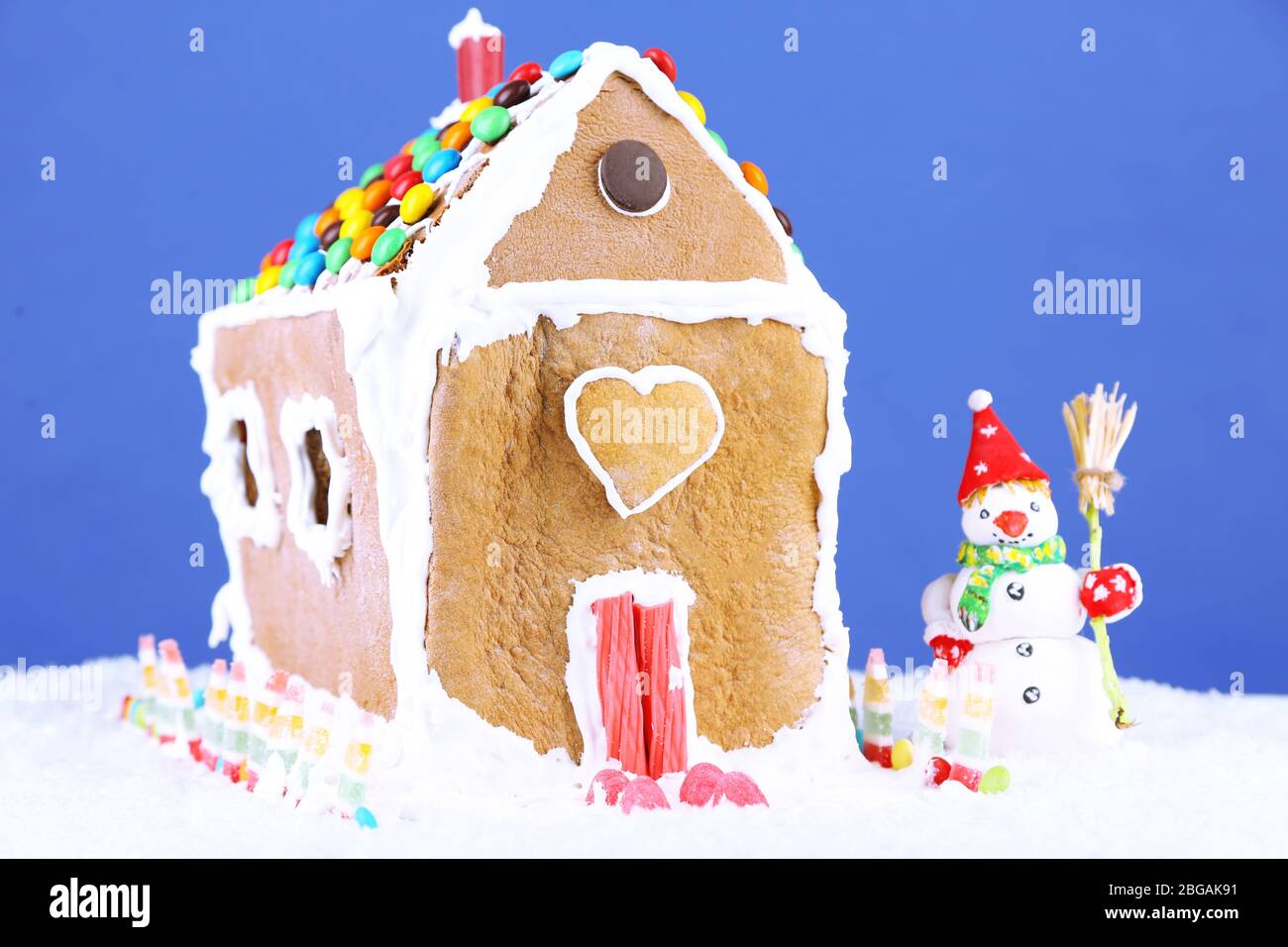 Gingerbread house on blue background Stock Photo - Alamy