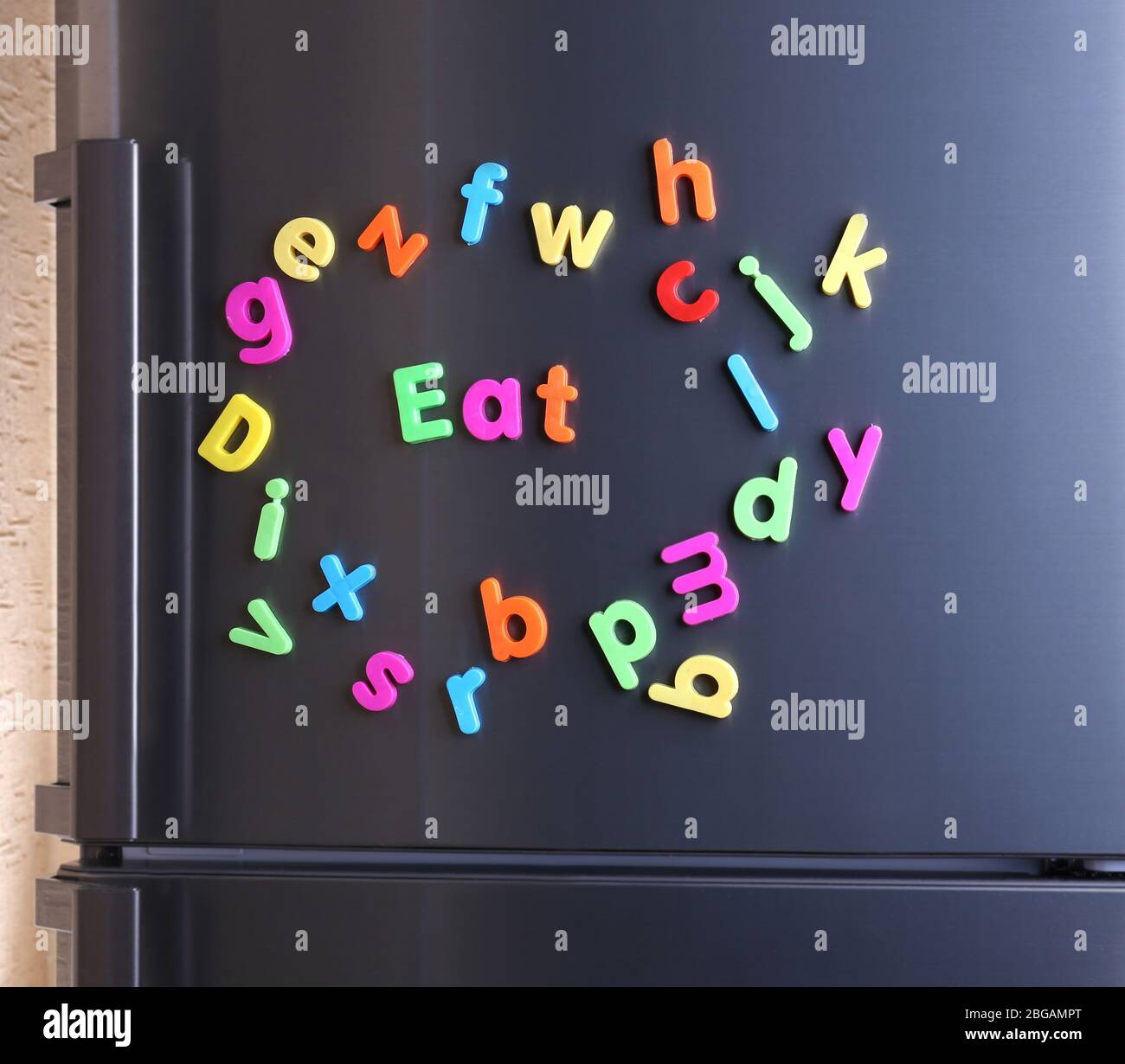 Word Eat spelled out using colorful magnetic letters on refrigerator ...