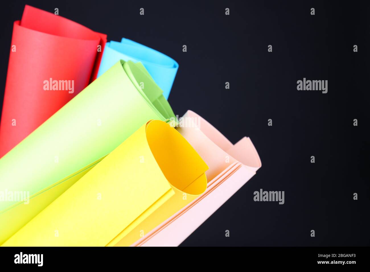 Colorful art paper on black background Stock Photo - Alamy