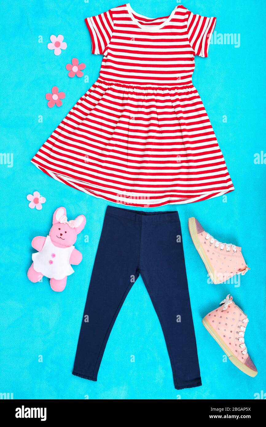 Beautiful clothes for little girl on blue background Stock Photo - Alamy