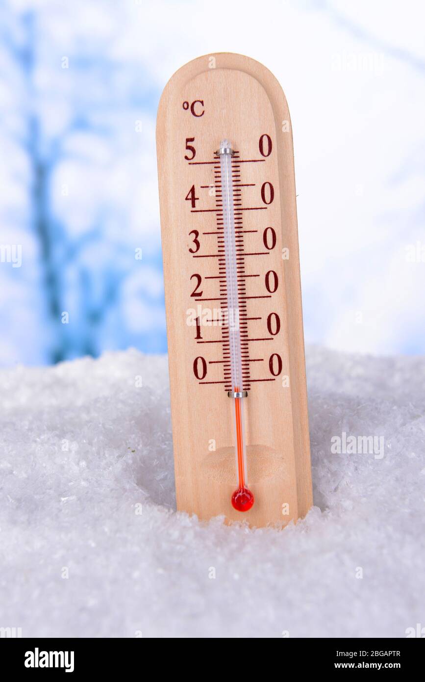 Thermometer in snow on light background Stock Photo - Alamy