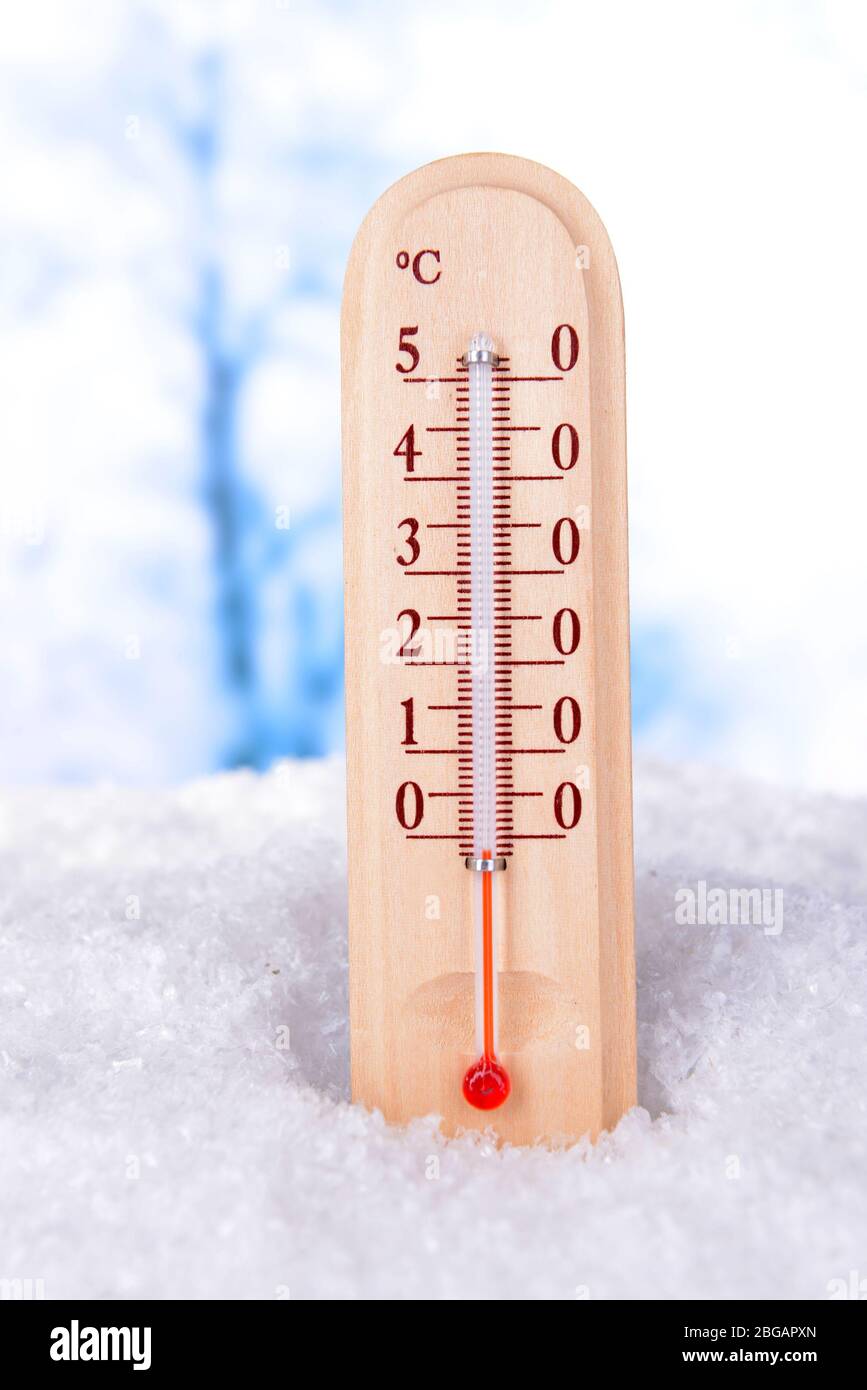Thermometer in snow on light background Stock Photo - Alamy