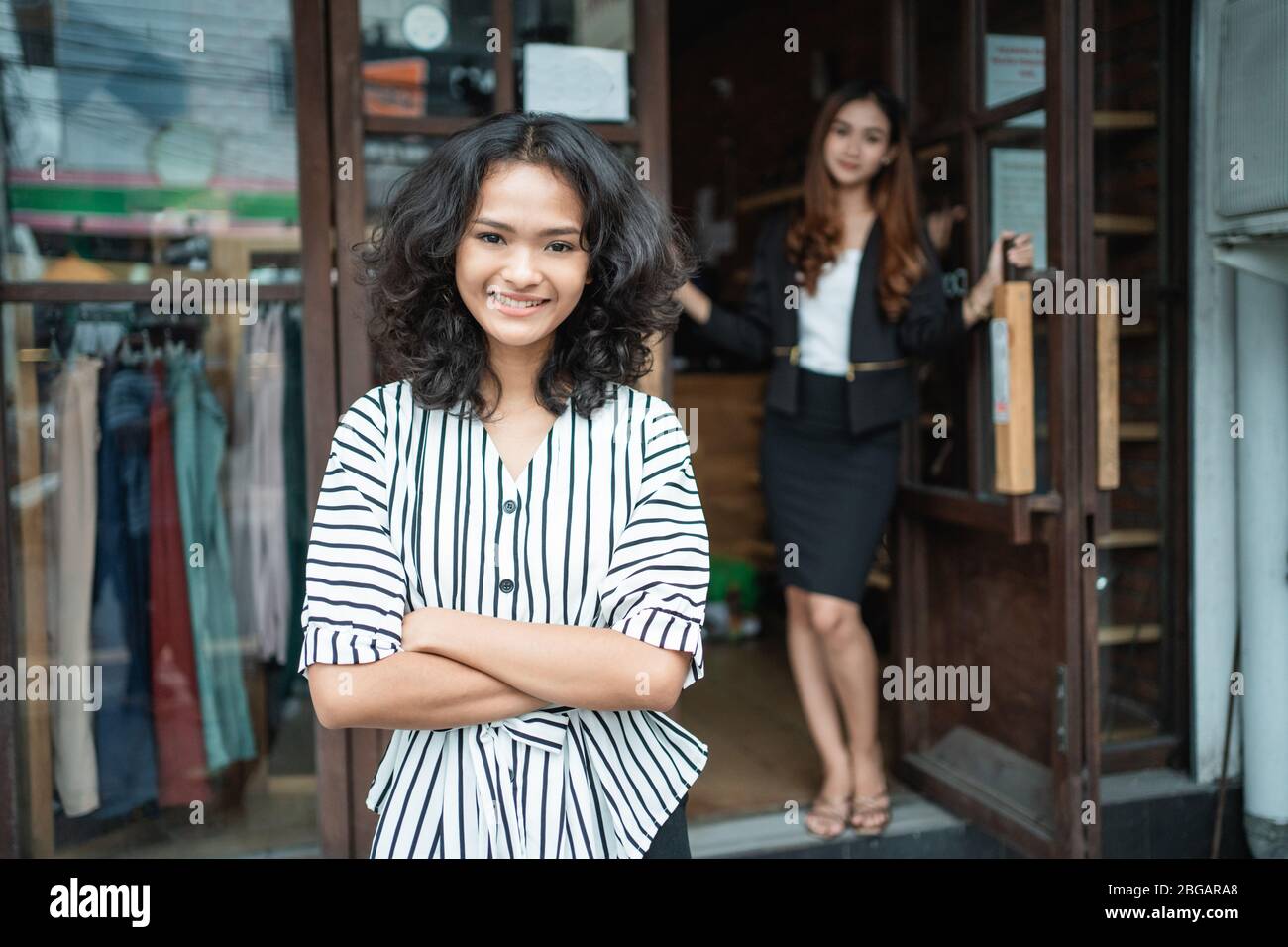 beautiful young asian fashion shop owner at her boutique standing ...
