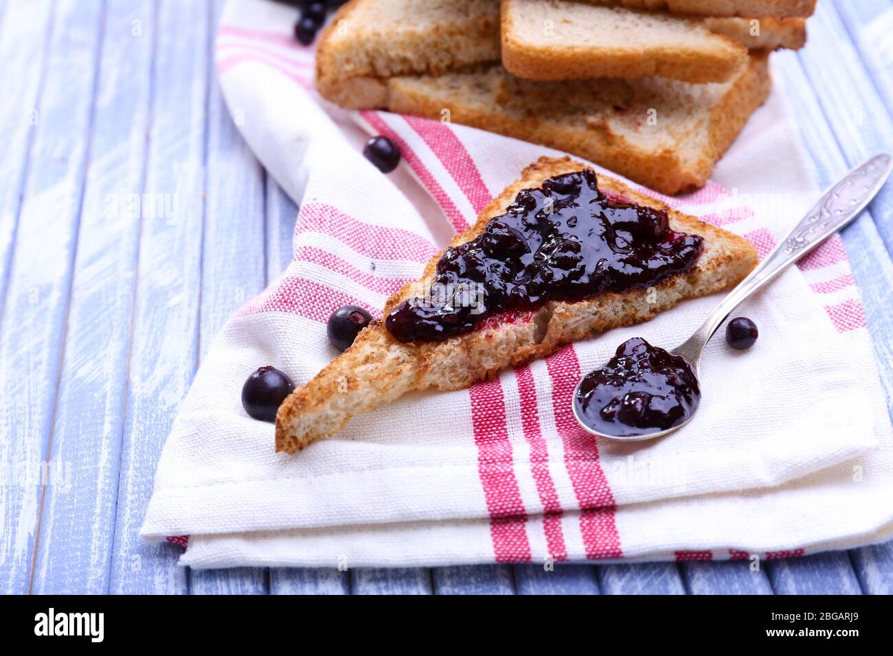 Delicious toast with jam on table close-up Stock Photo - Alamy