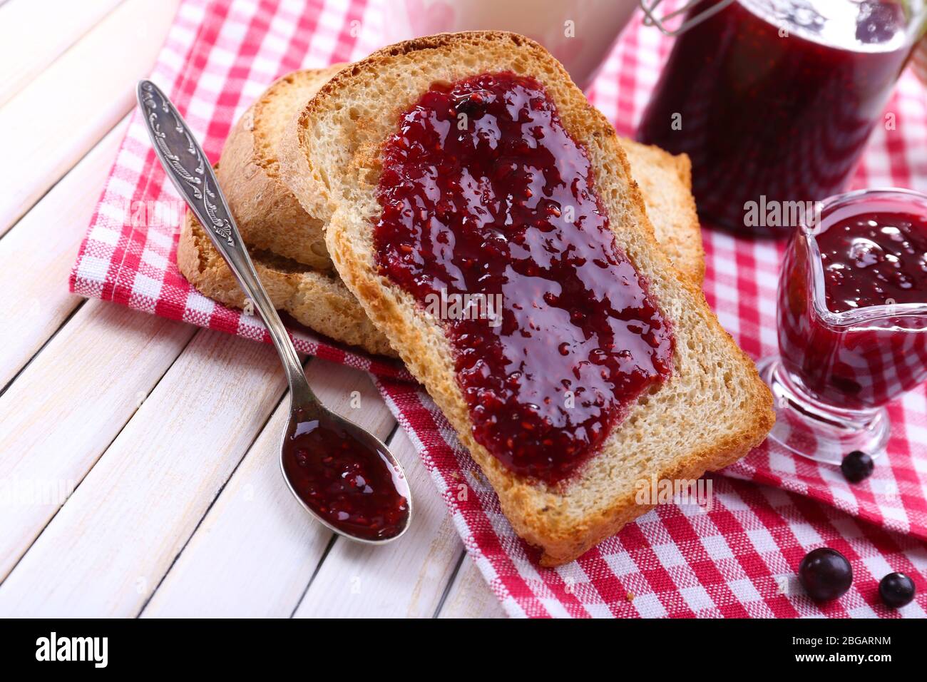Delicious toast with jam on table close-up Stock Photo - Alamy