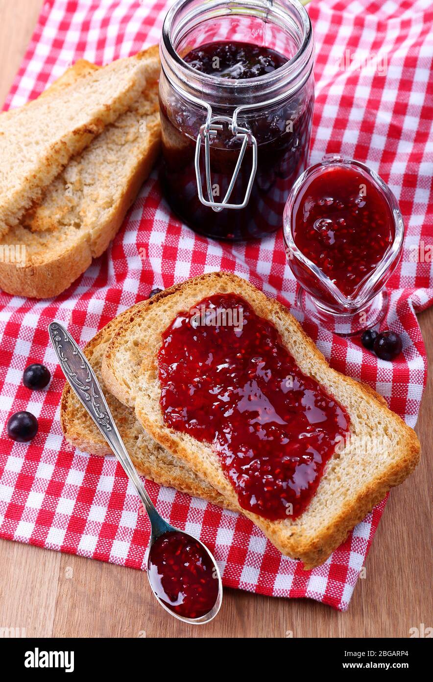 Delicious toast with jam on table close-up Stock Photo - Alamy