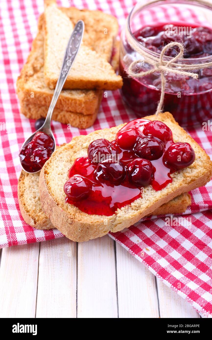 Delicious toast with jam on table close-up Stock Photo - Alamy
