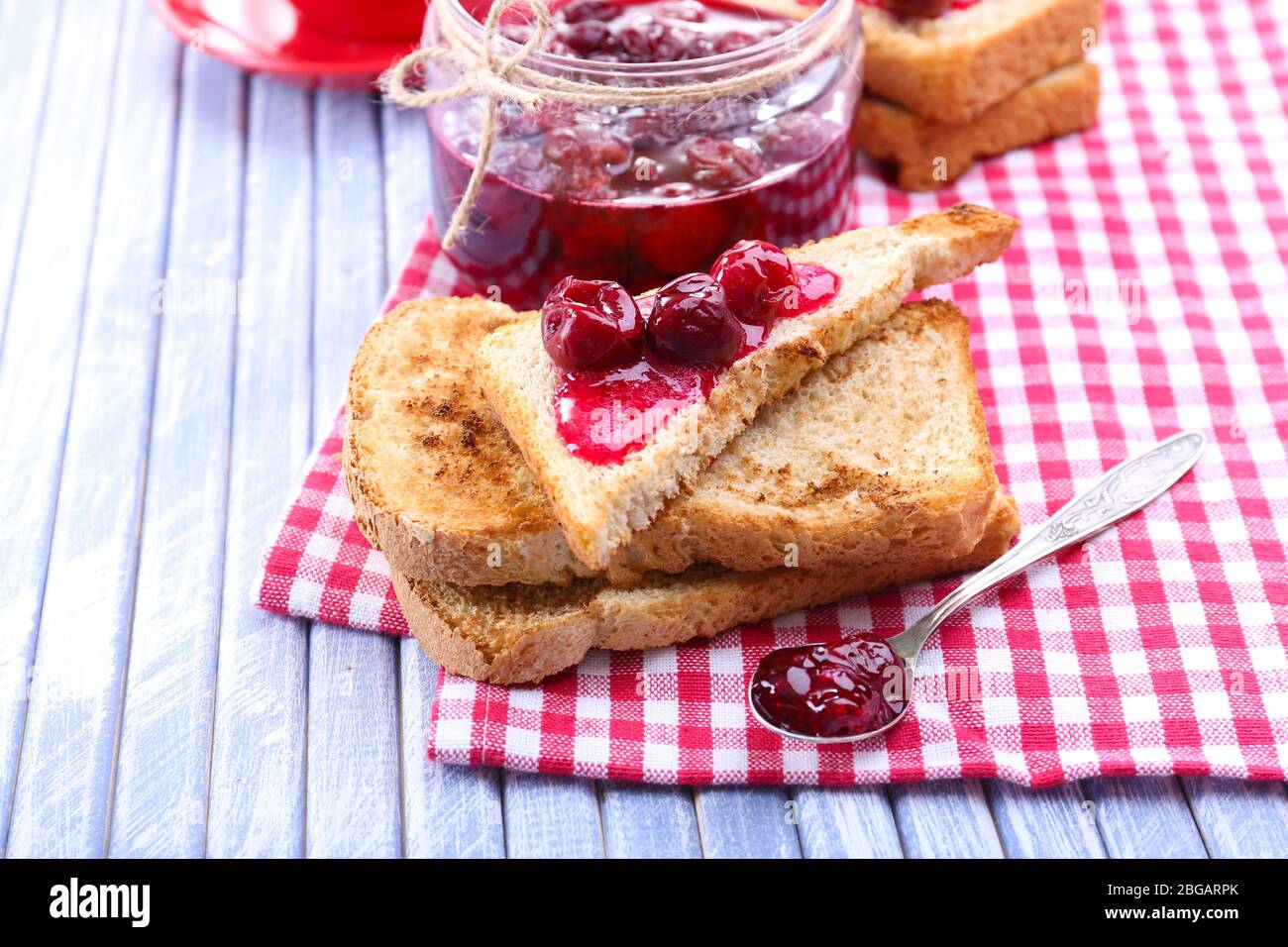 Delicious toast with jam on table close-up Stock Photo - Alamy