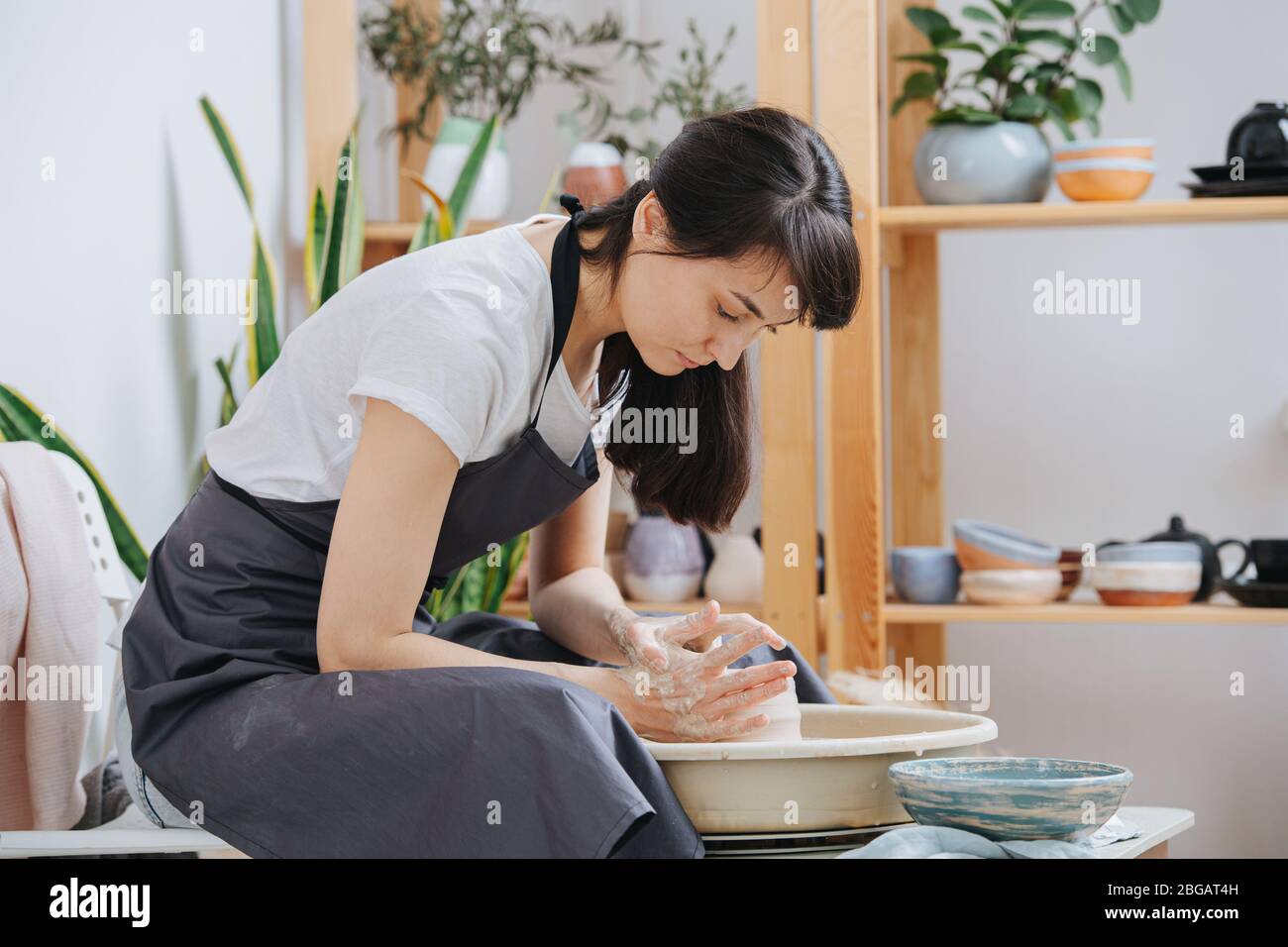 Serious woman working pottery wheel hi-res stock photography and images ...