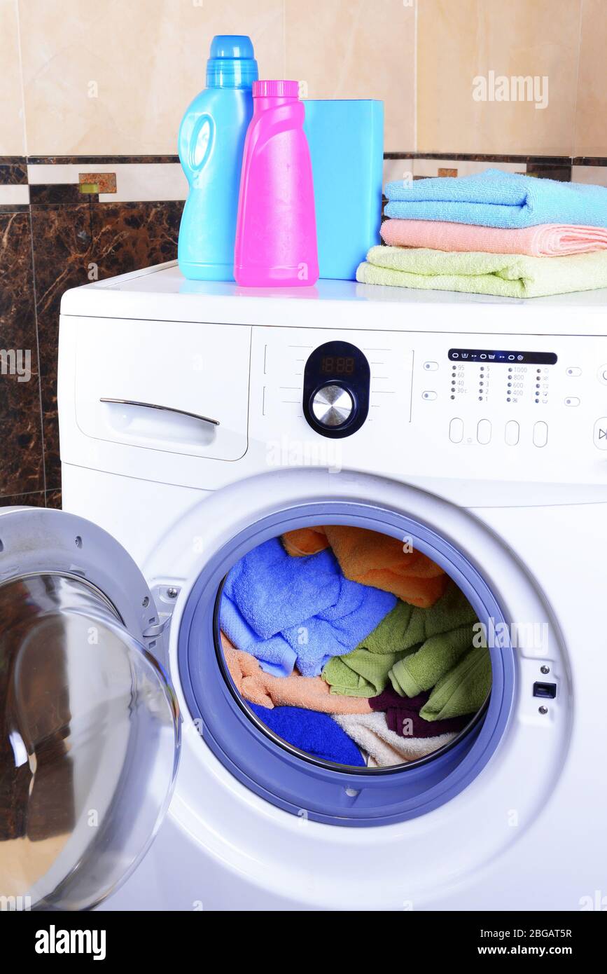 Washing machine loaded with clothes close-up Stock Photo - Alamy
