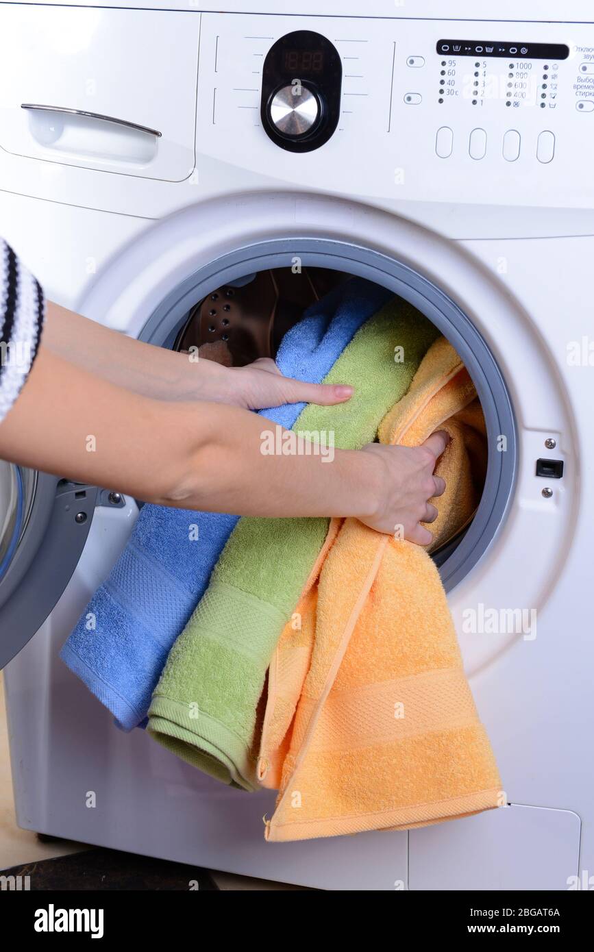 Washing machine loaded with clothes close-up Stock Photo - Alamy