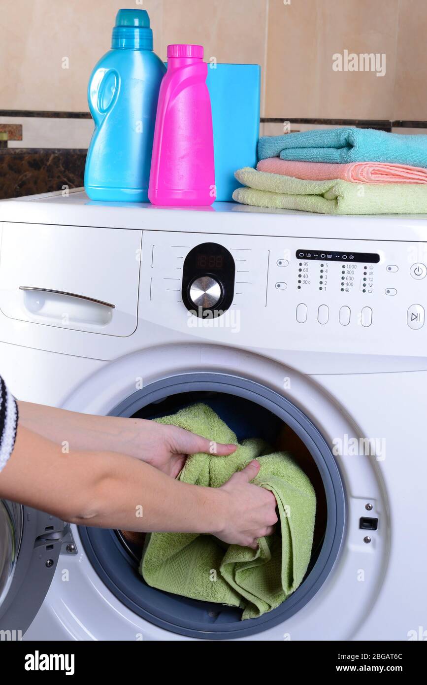 Washing machine loaded with clothes close-up Stock Photo - Alamy