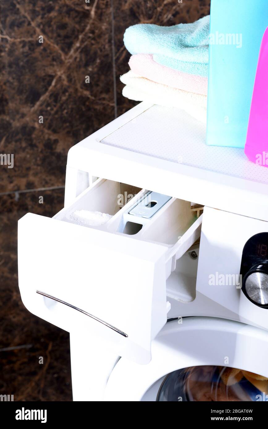 Washing machine loaded with clothes close-up Stock Photo - Alamy