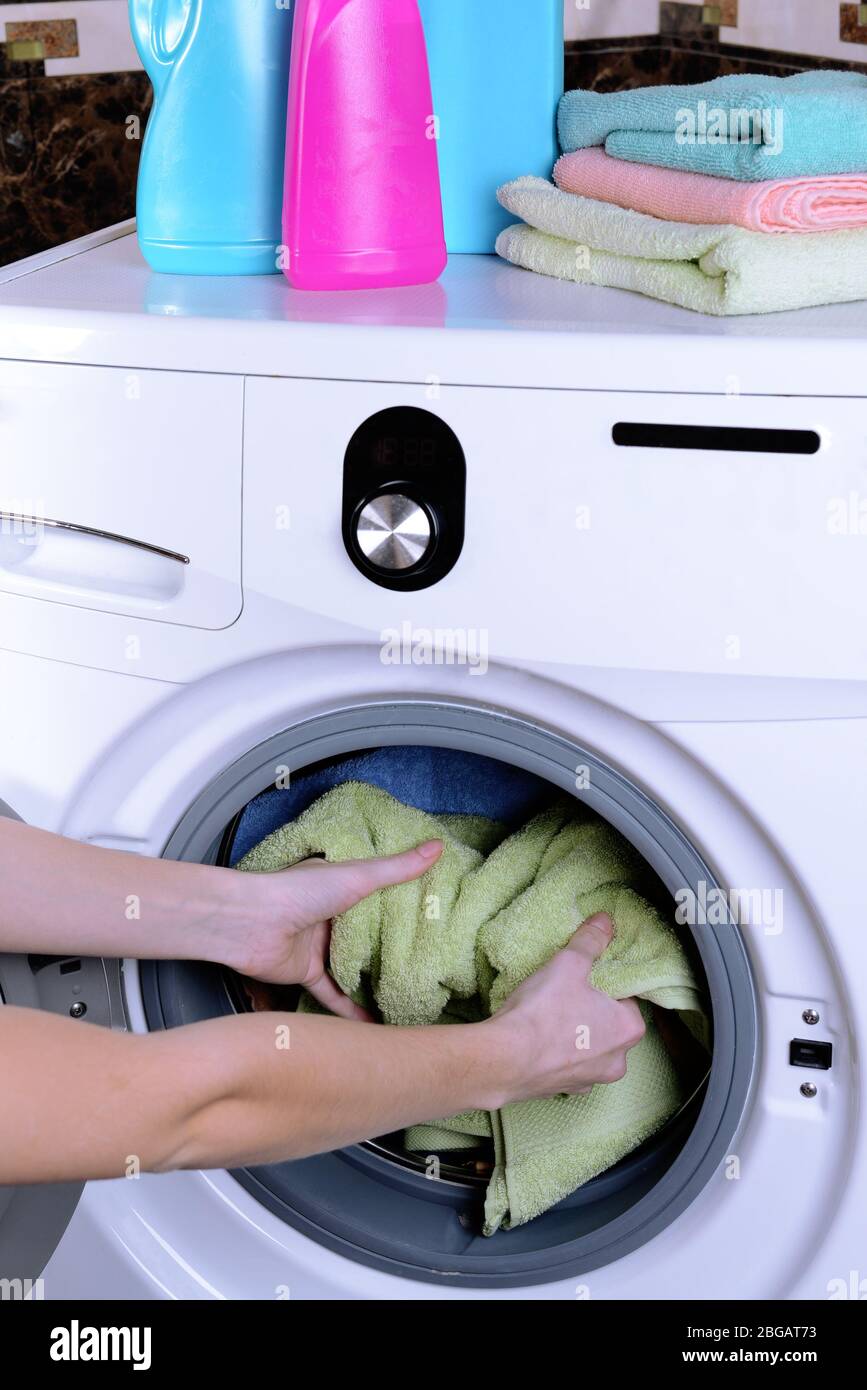 Washing machine loaded with clothes close-up Stock Photo - Alamy