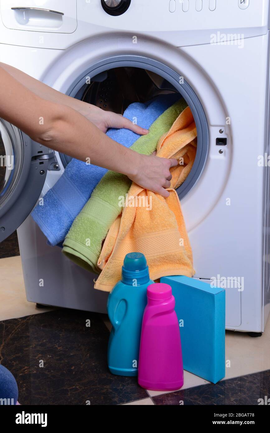 Washing machine loaded with clothes close-up Stock Photo - Alamy