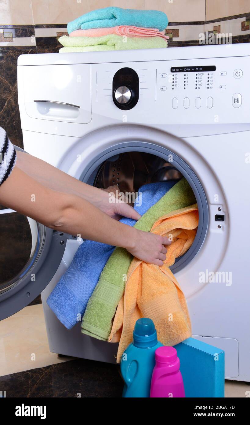 Washing machine loaded with clothes close-up Stock Photo - Alamy