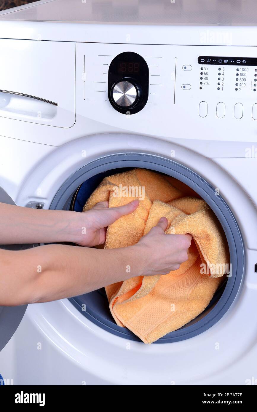 Washing machine loaded with clothes close-up Stock Photo - Alamy