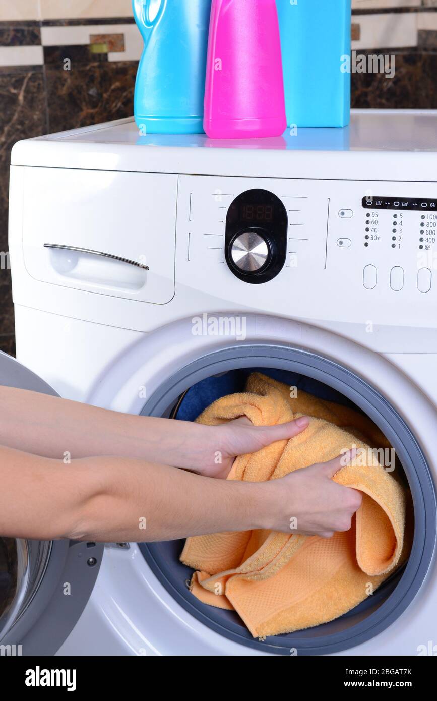 Washing machine loaded with clothes close-up Stock Photo - Alamy
