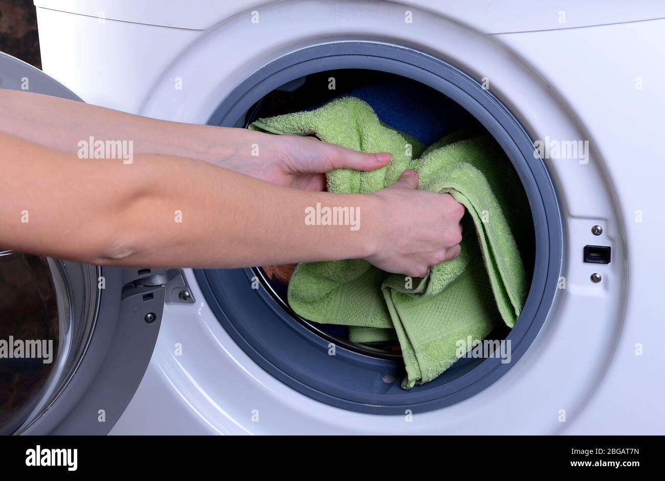 Washing machine loaded with clothes close-up Stock Photo - Alamy