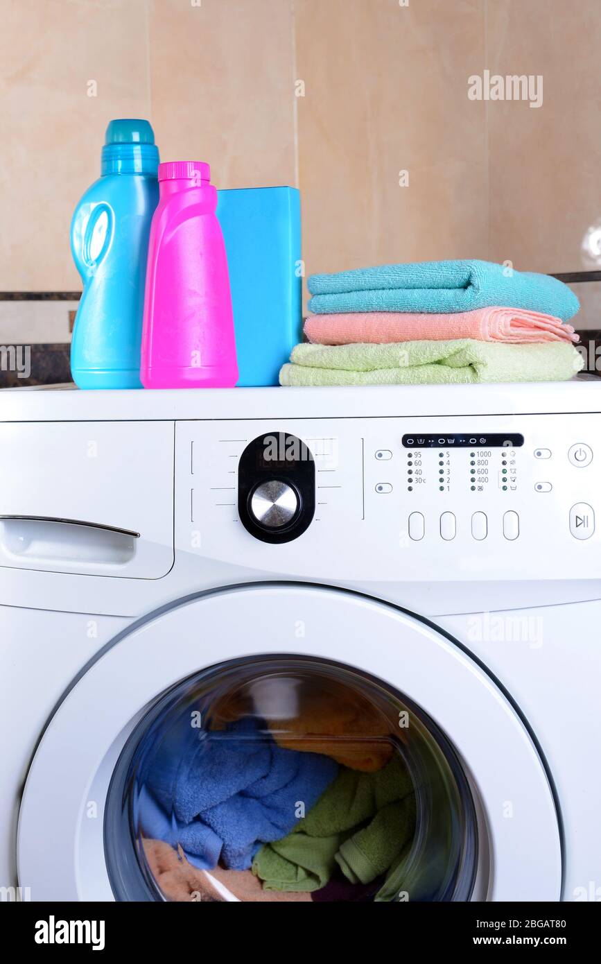 Washing machine loaded with clothes close-up Stock Photo - Alamy