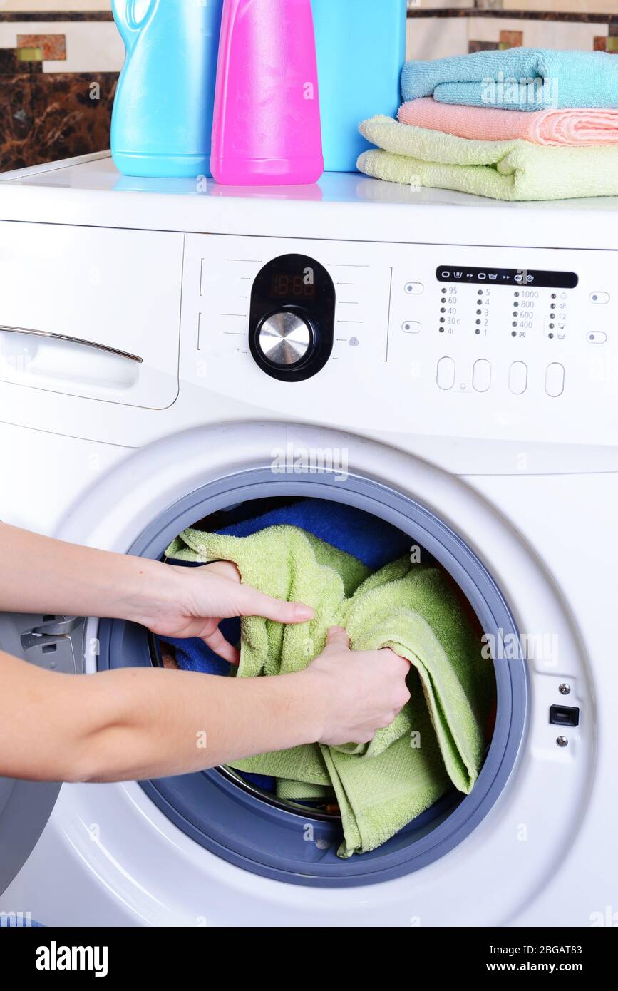 Washing machine loaded with clothes close-up Stock Photo - Alamy