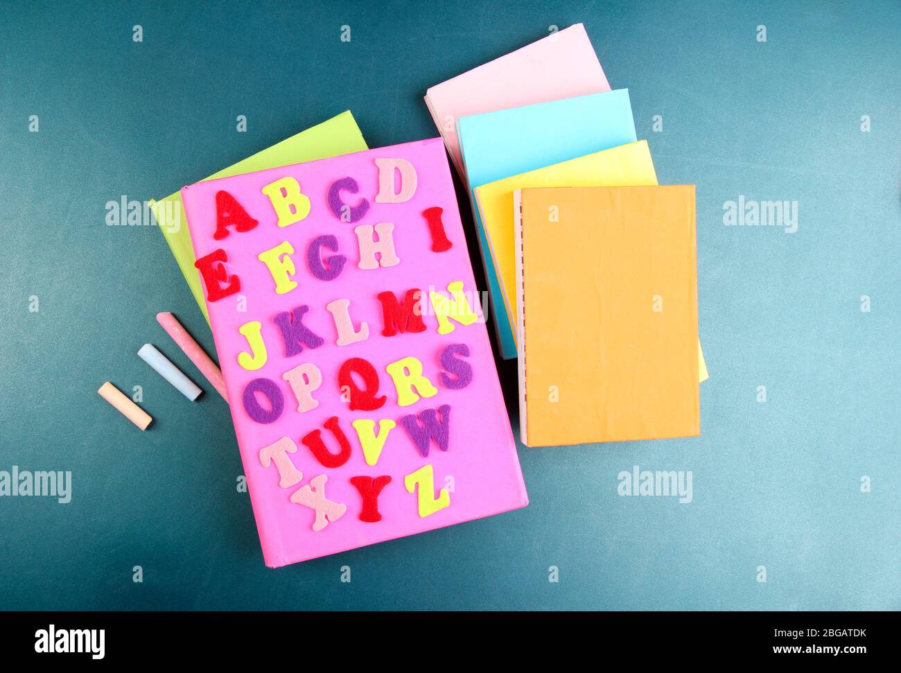 English alphabet, books and markers on school desk Stock Photo - Alamy