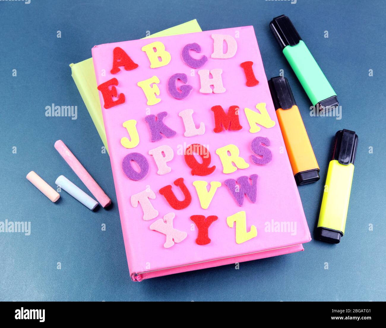 English alphabet, books and markers on school desk Stock Photo - Alamy