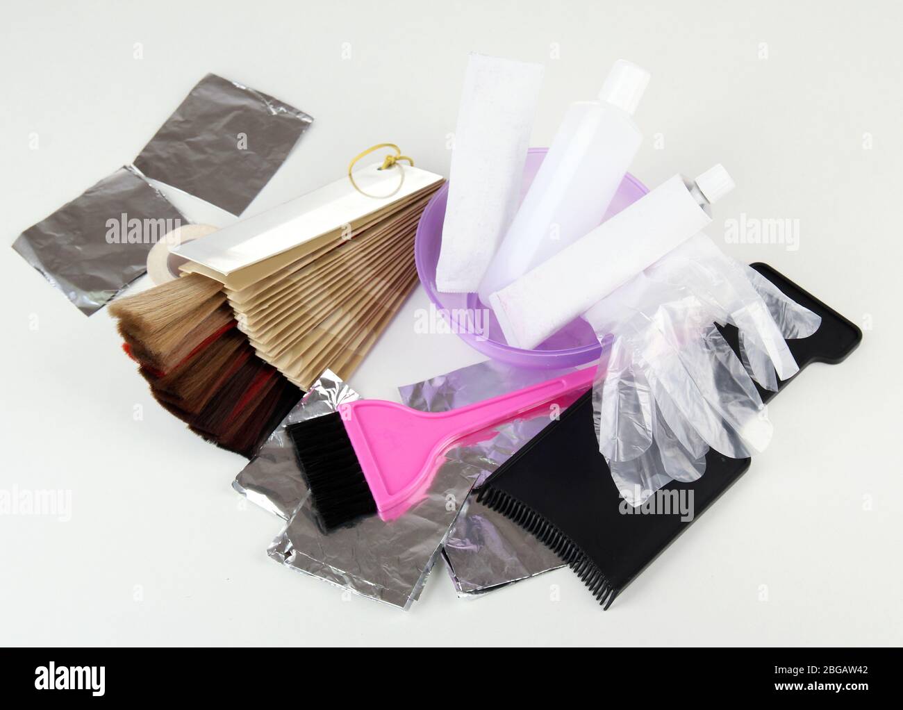 Hair dye kit and hair samples of different colors, isolated on white ...
