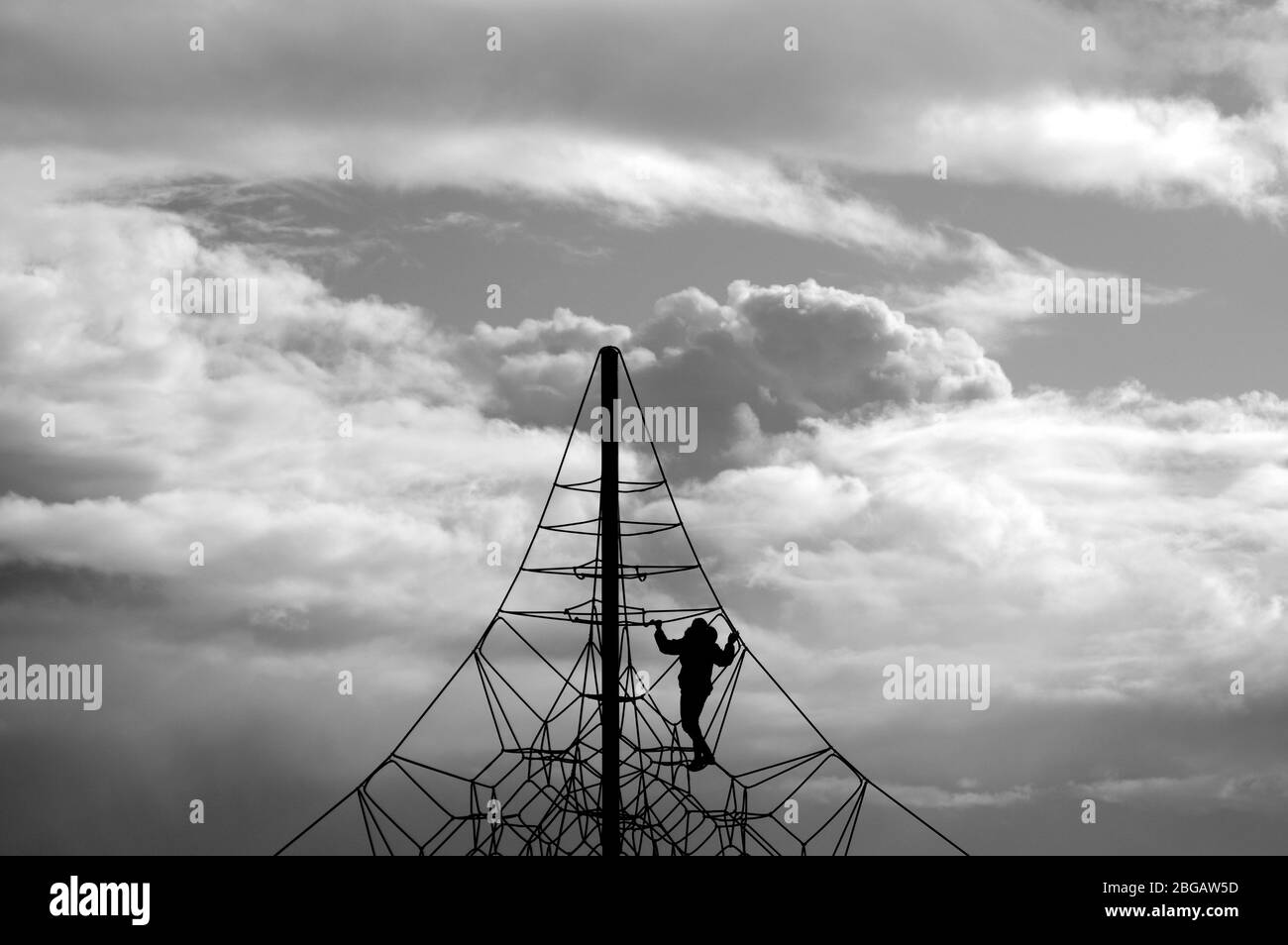 A crocheted web of ropes against the sky. Rope climbing toys for kids ...
