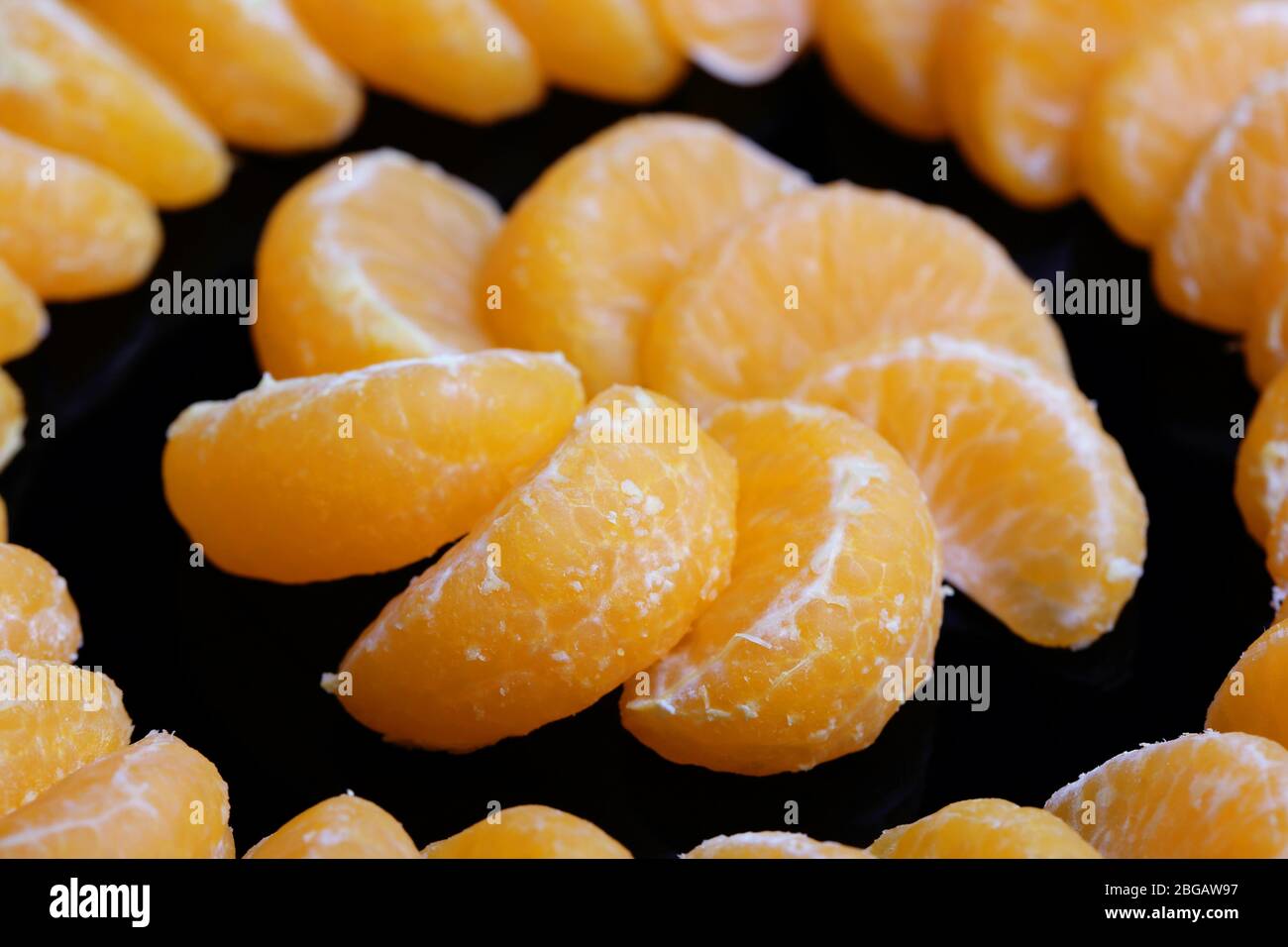 Ripe sweet tangerine slices, close-up Stock Photo - Alamy