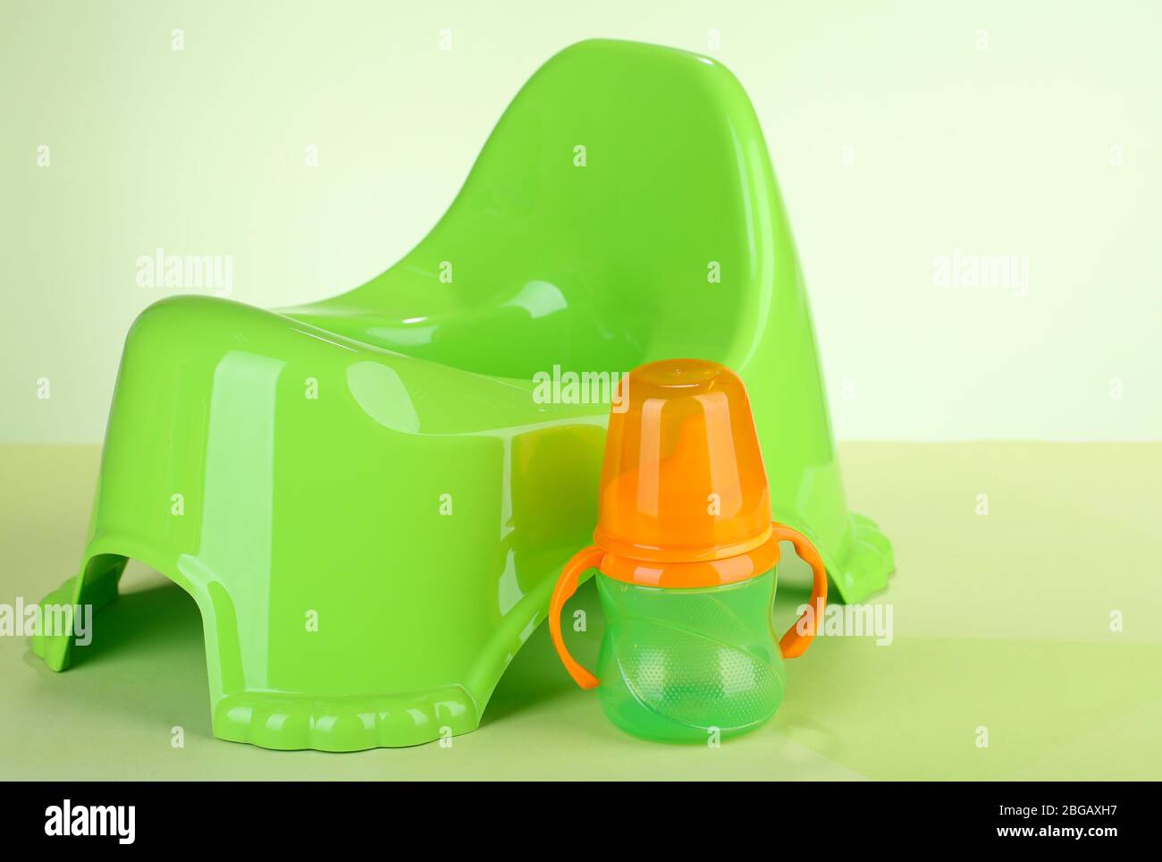 Green potty on color background Stock Photo - Alamy
