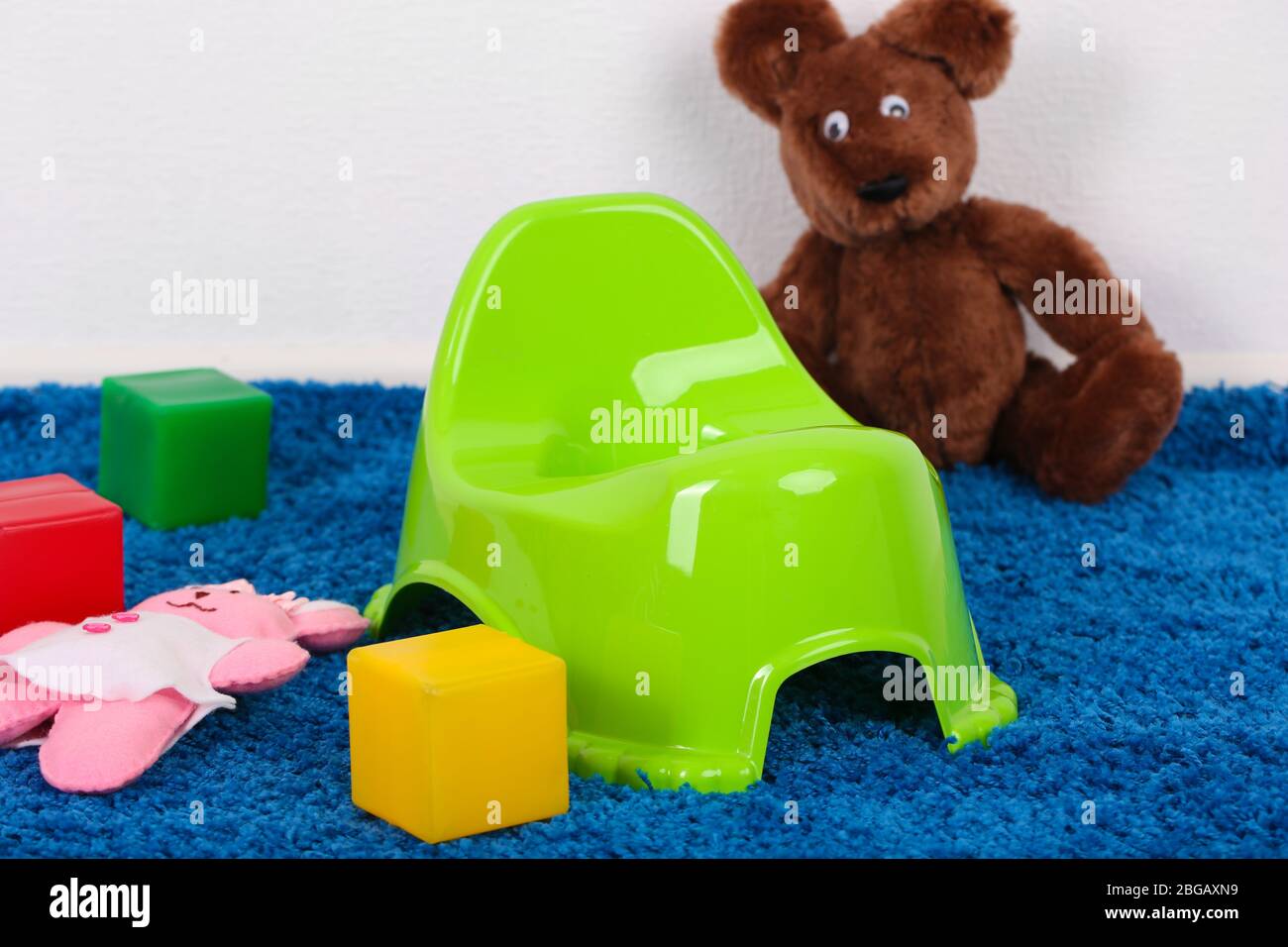 Green potty on home interior background Stock Photo - Alamy