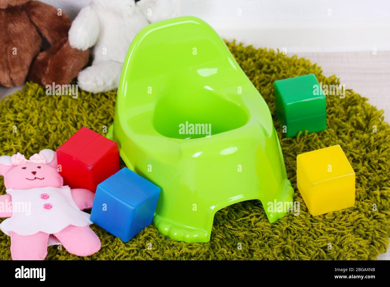 Green potty on home interior background Stock Photo - Alamy