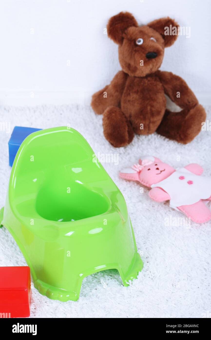 Green potty on home interior background Stock Photo - Alamy