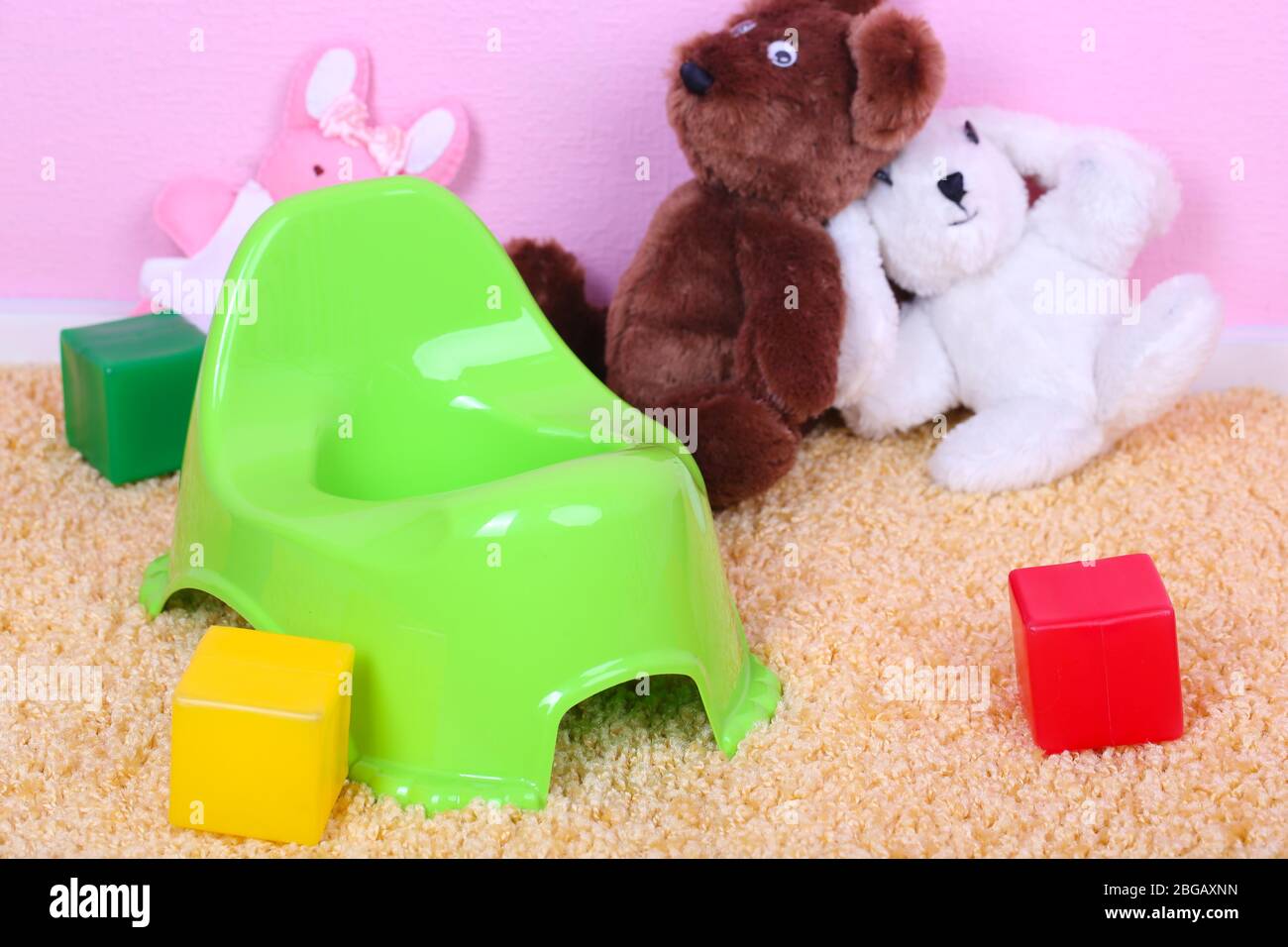 Green potty on home interior background Stock Photo - Alamy