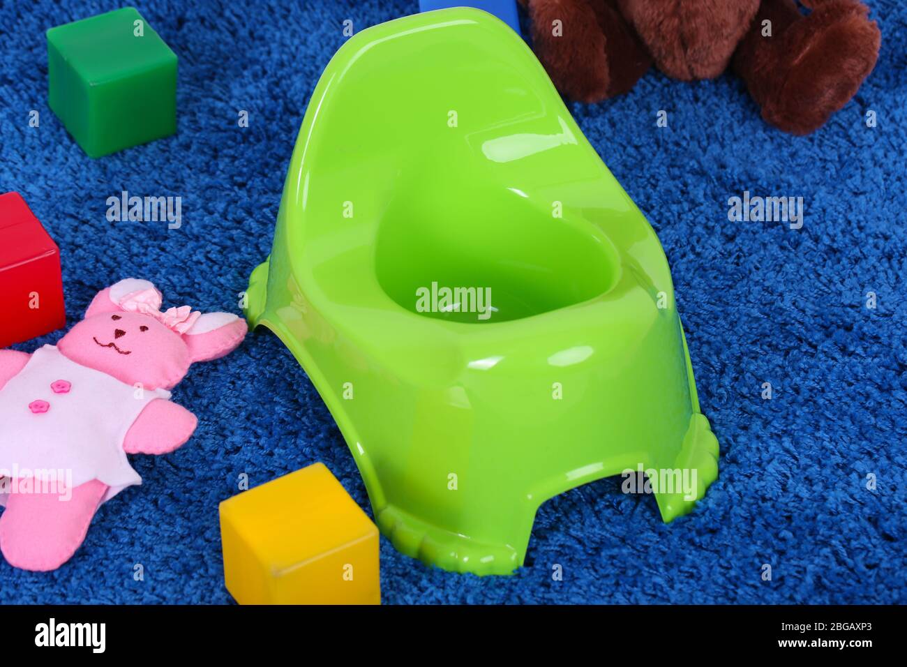 Green potty on home interior background Stock Photo - Alamy