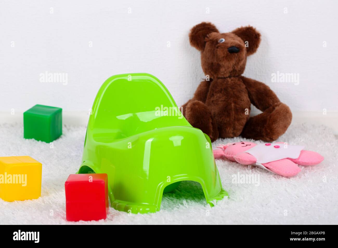 Green potty on home interior background Stock Photo - Alamy
