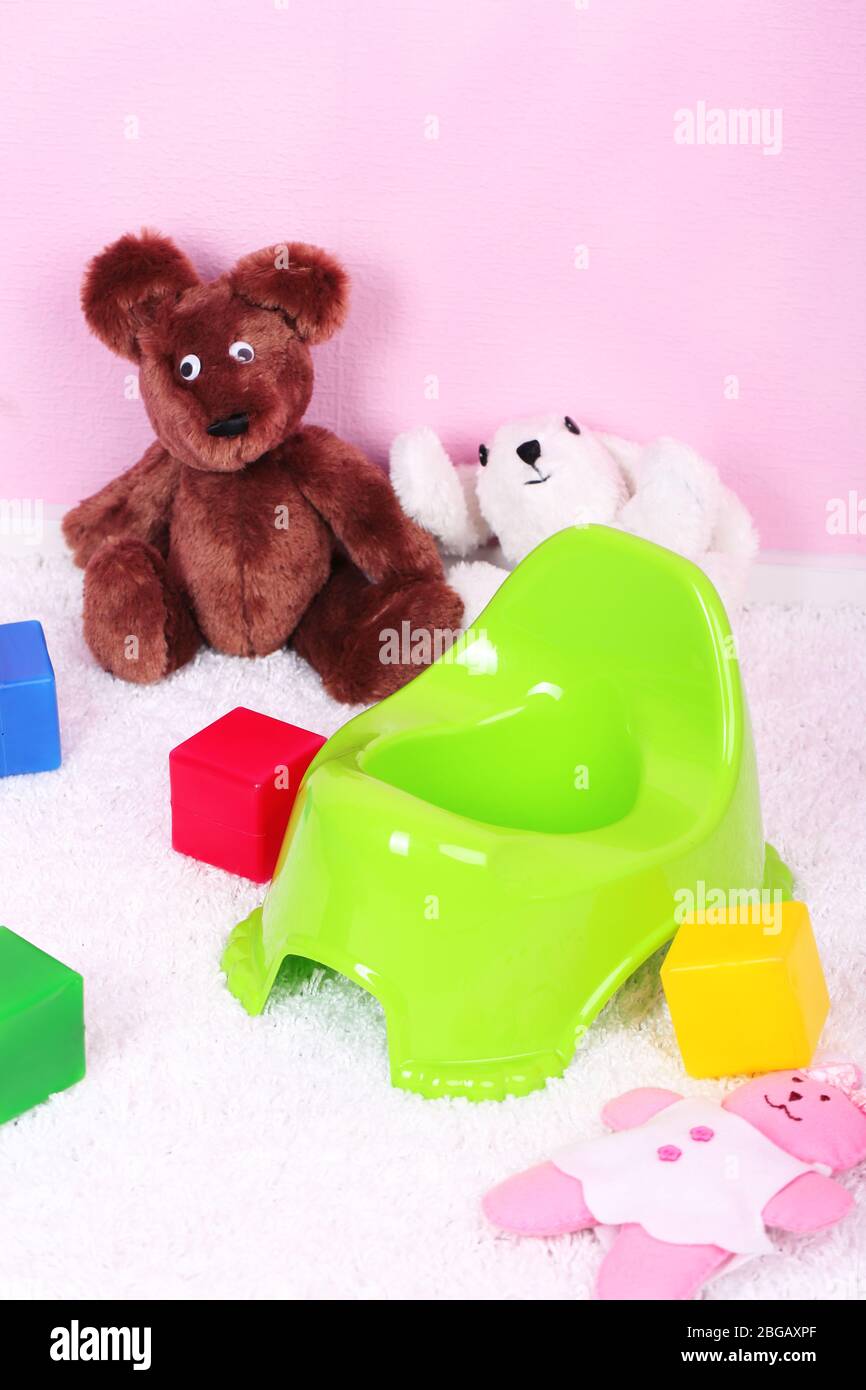 Green potty on home interior background Stock Photo - Alamy