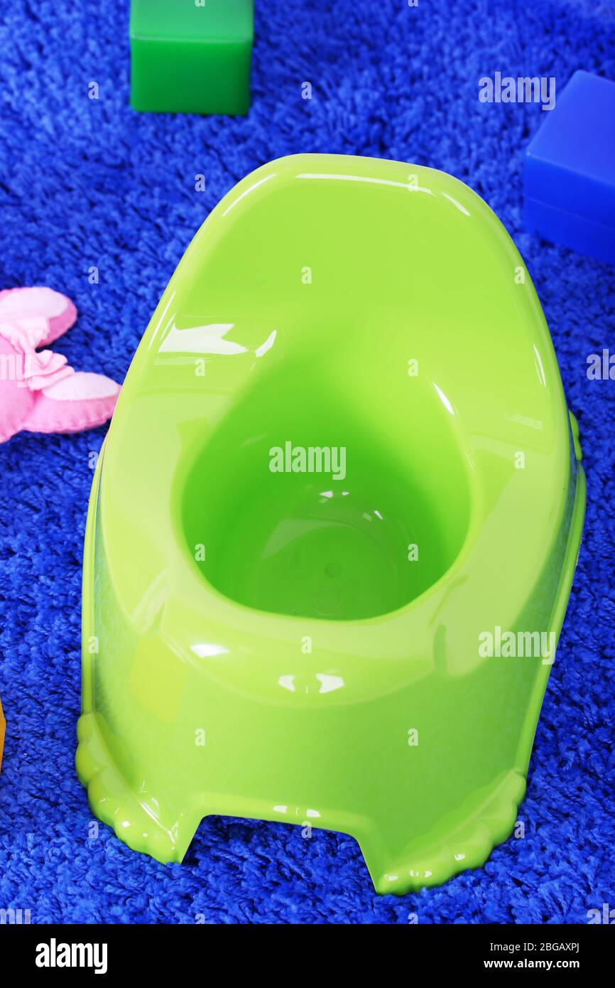 Green potty on home interior background Stock Photo - Alamy