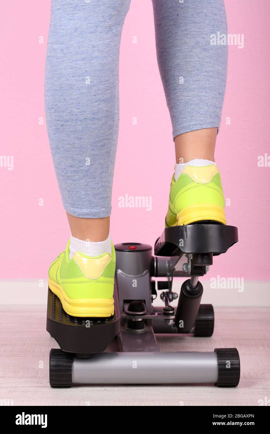 Woman doing exercise on stepper. Close-up on legs Stock Photo - Alamy
