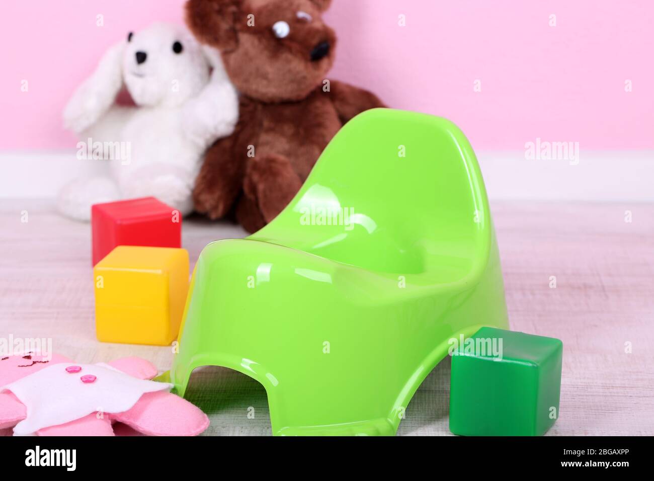 Green potty on home interior background Stock Photo - Alamy