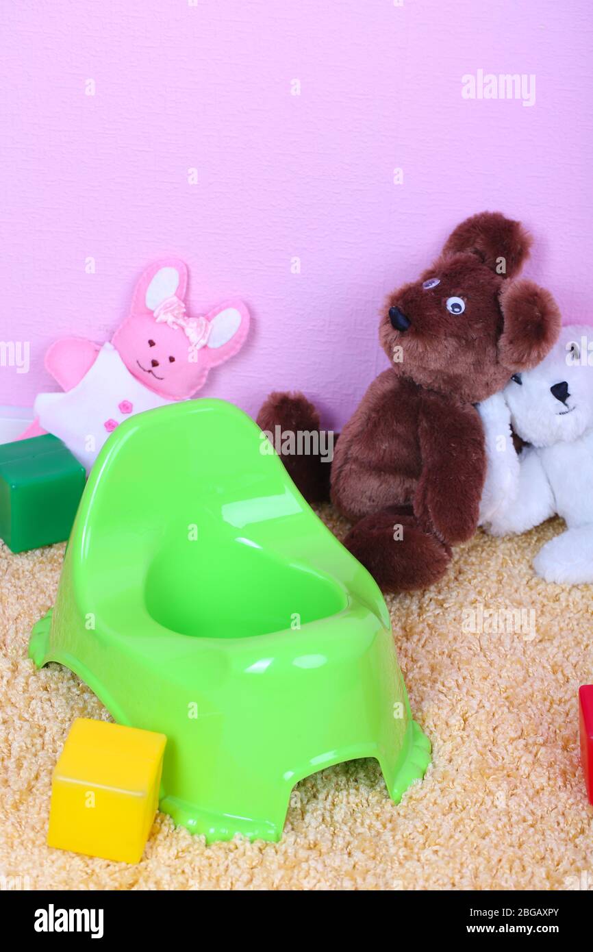 Green potty on home interior background Stock Photo - Alamy