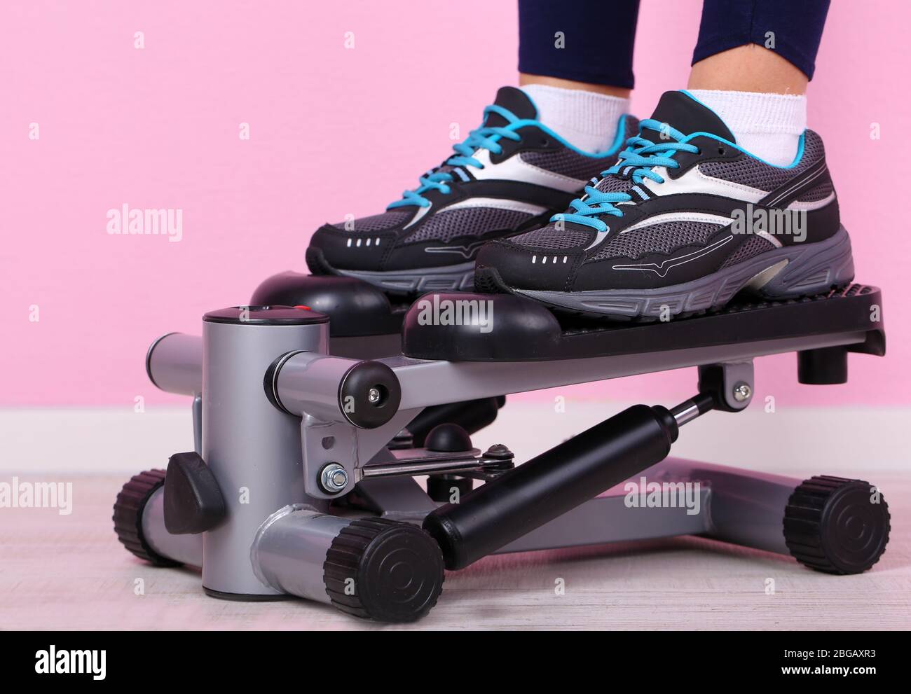 Woman doing exercise on stepper. Close-up on legs Stock Photo - Alamy