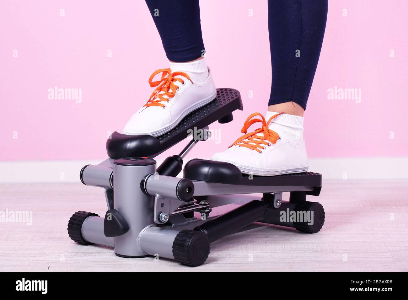 Woman doing exercise on stepper. Close-up on legs Stock Photo - Alamy