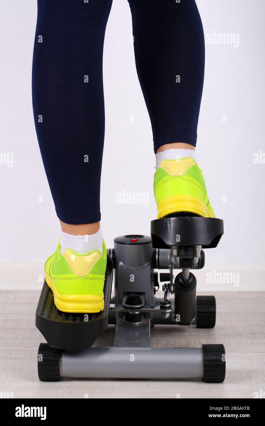 Woman doing exercise on stepper. Close-up on legs Stock Photo - Alamy