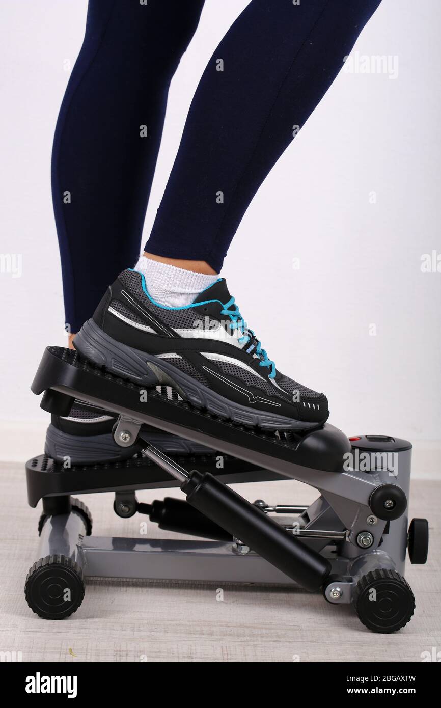 Woman doing exercise on stepper. Close-up on legs Stock Photo - Alamy